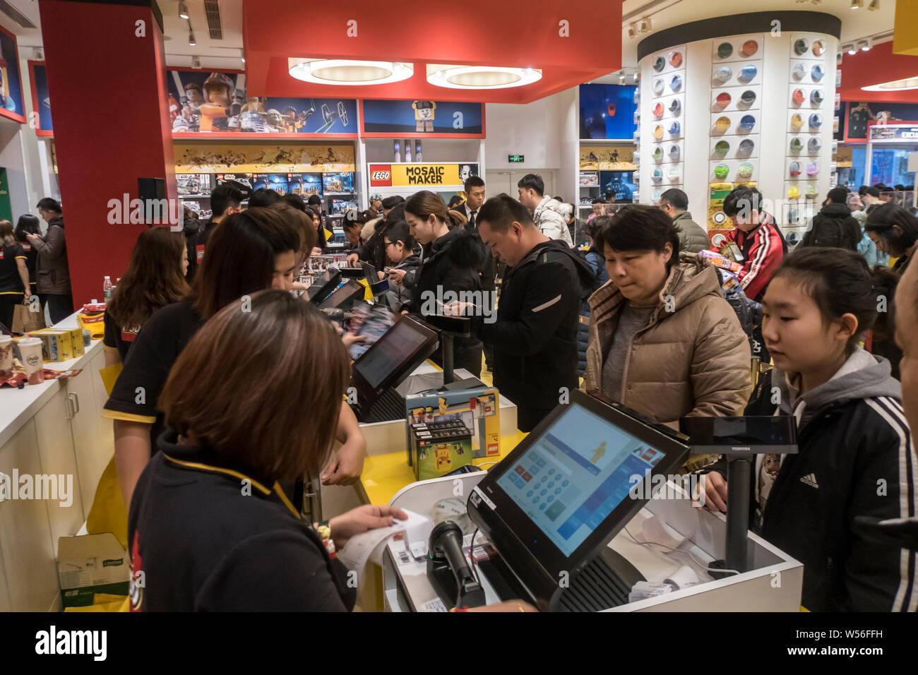 Customers shop in the first Beijing flagship store in the Wangfujing ...