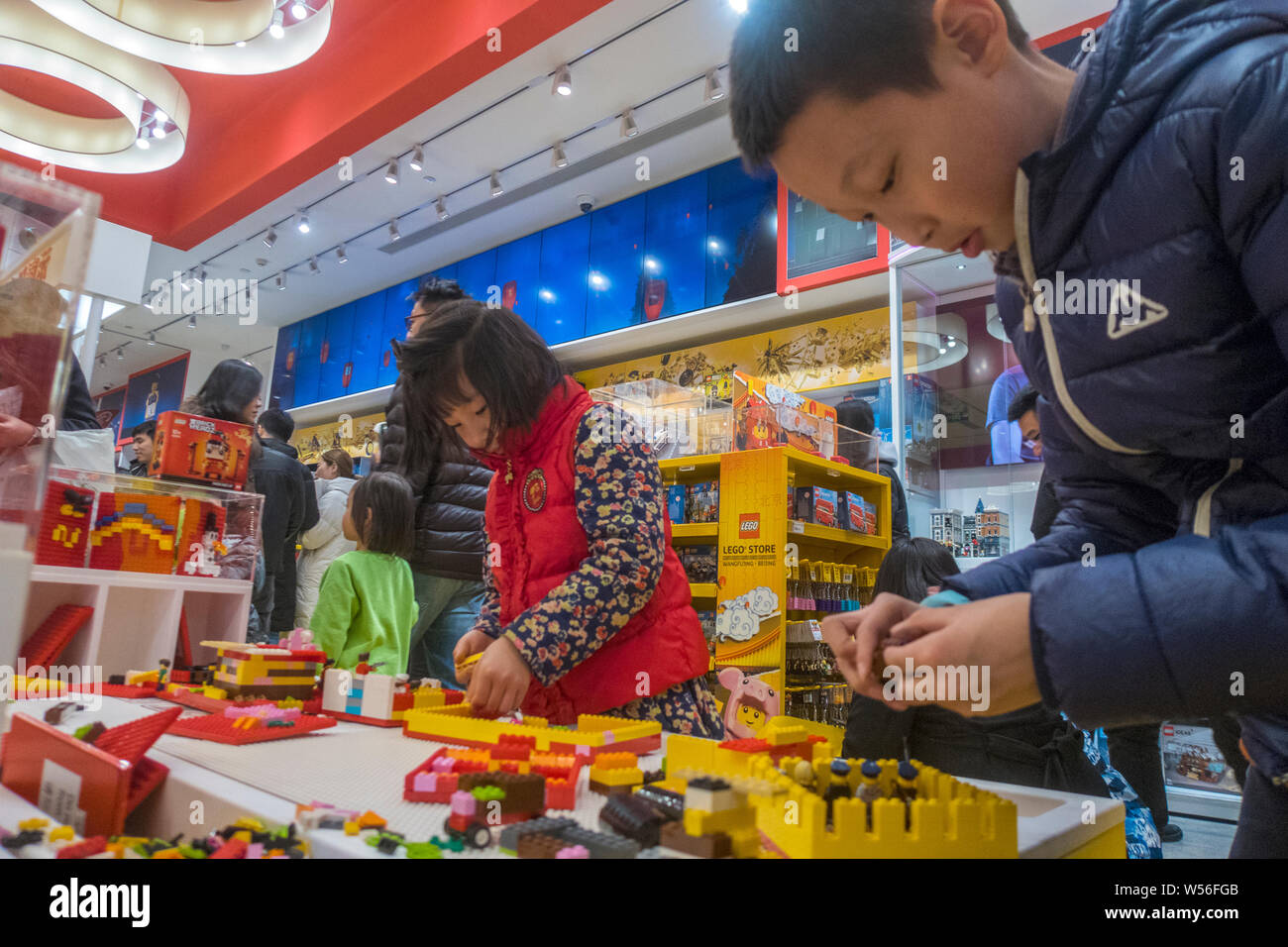 Customers shop in the first Beijing flagship store in the Wangfujing ...