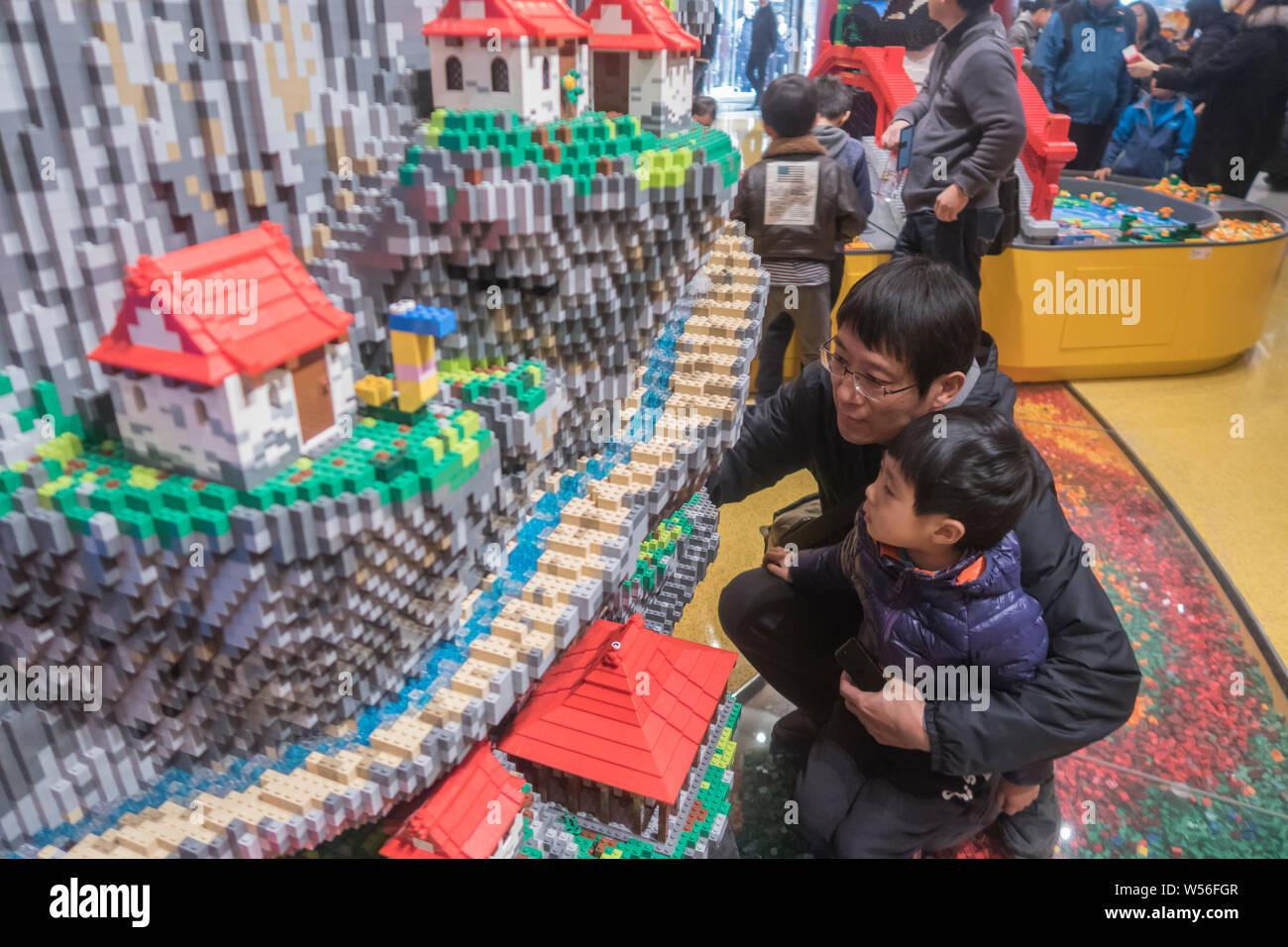 Customers shop in the first Beijing flagship store in the Wangfujing ...
