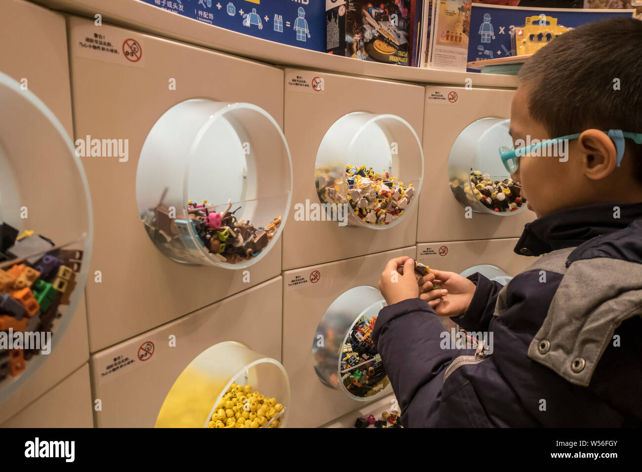 Customers shop in the first Beijing flagship store in the Wangfujing ...