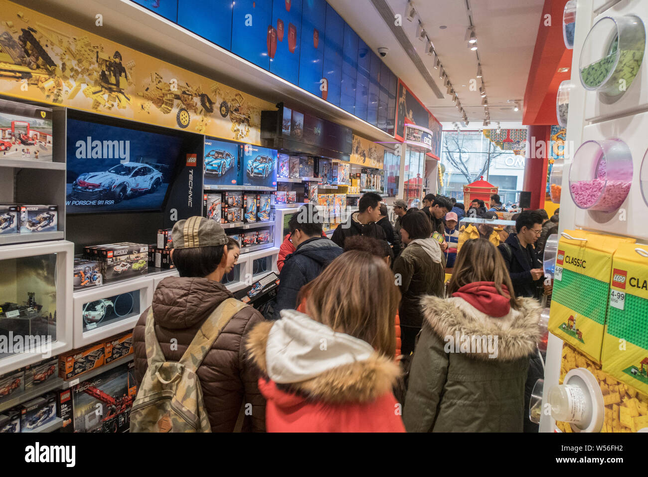 Customers shop in the first Beijing flagship store in the Wangfujing ...