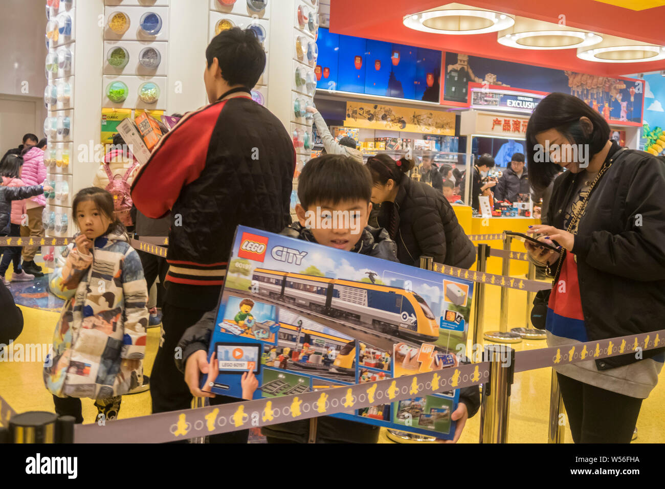 Customers shop in the first Beijing flagship store in the Wangfujing ...