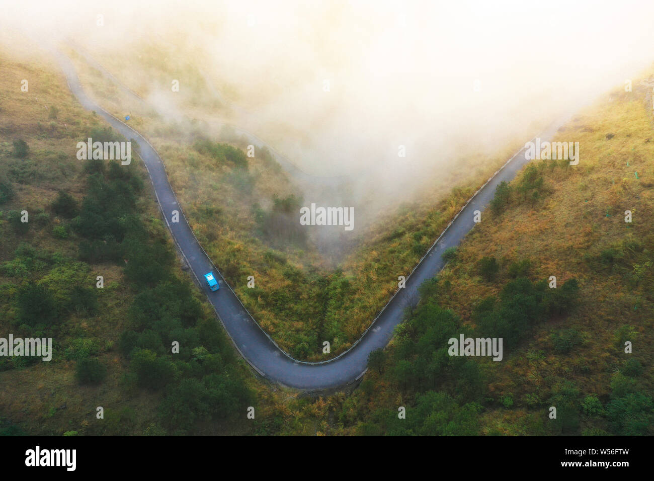 View of the mountain road in cloud and mist at Qibainong National ...