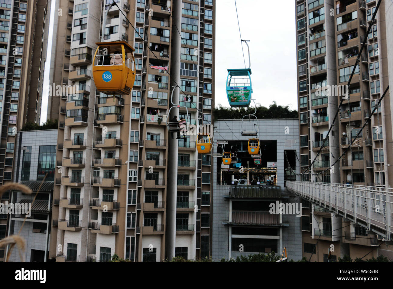 View of the cable cars on a cableway going through two residential ...