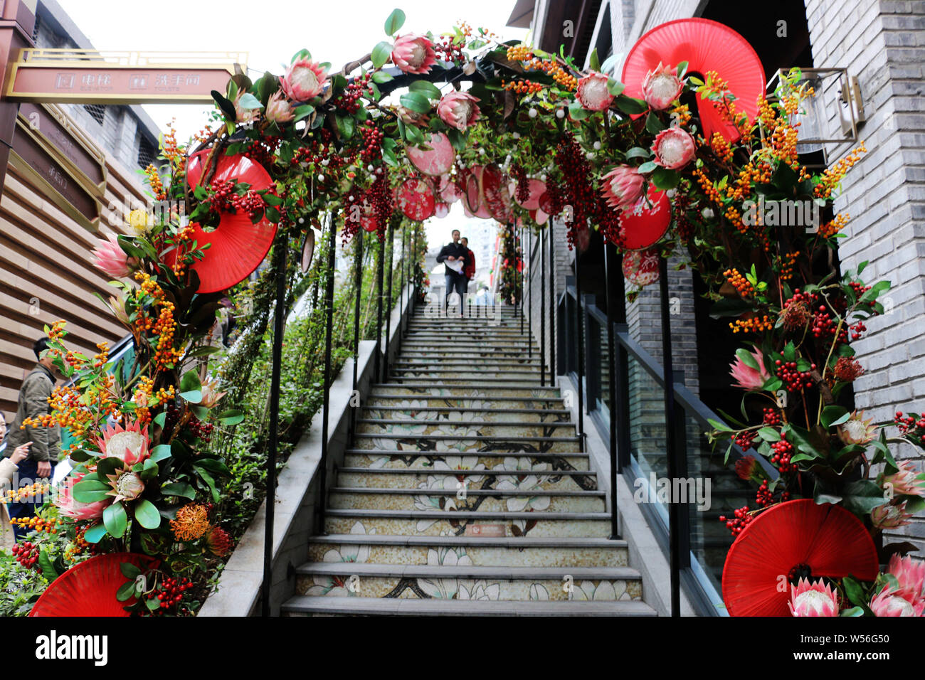 Pedestrians walk on flower painted stairs in Nan'an district, Chongqing ...