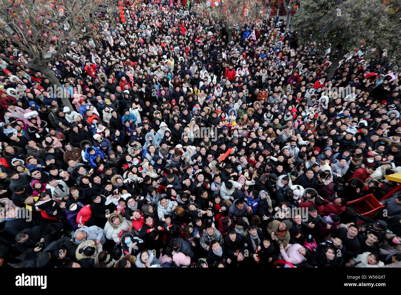 Tourists crowd the Millennium City Park to get red pocket money from ...
