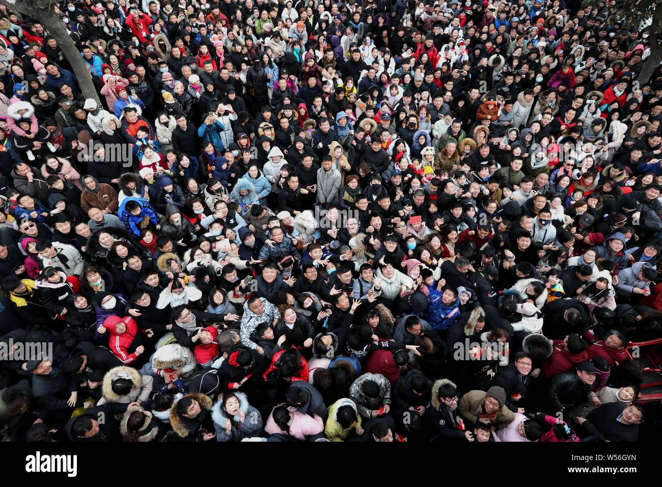 Tourists crowd the Millennium City Park to get red pocket money from ...