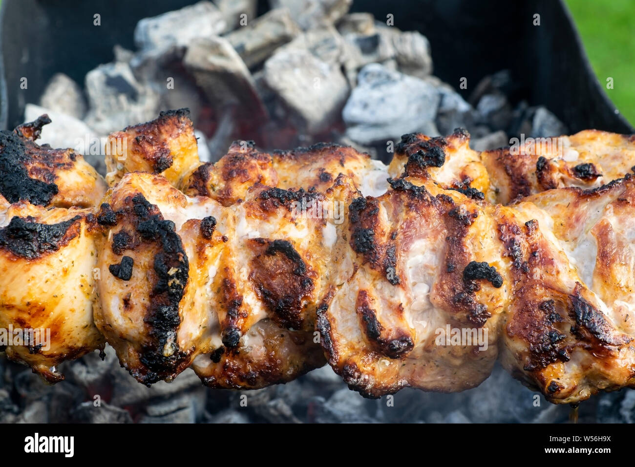 Marinated chicken kebab is cooked on the grill on the coals. Kebab ...