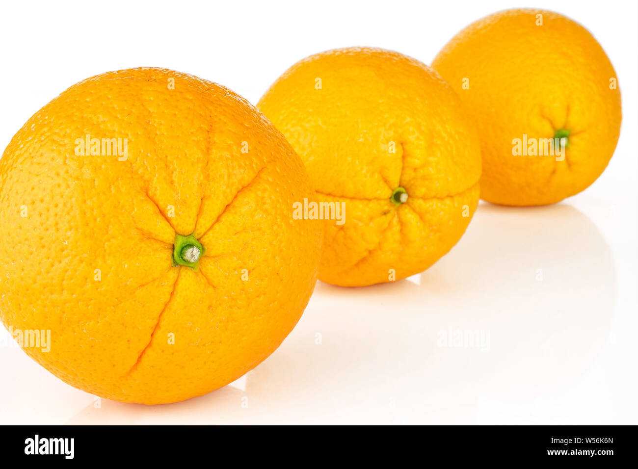 Group of three whole fresh sweet orange placed diagonally isolated on ...