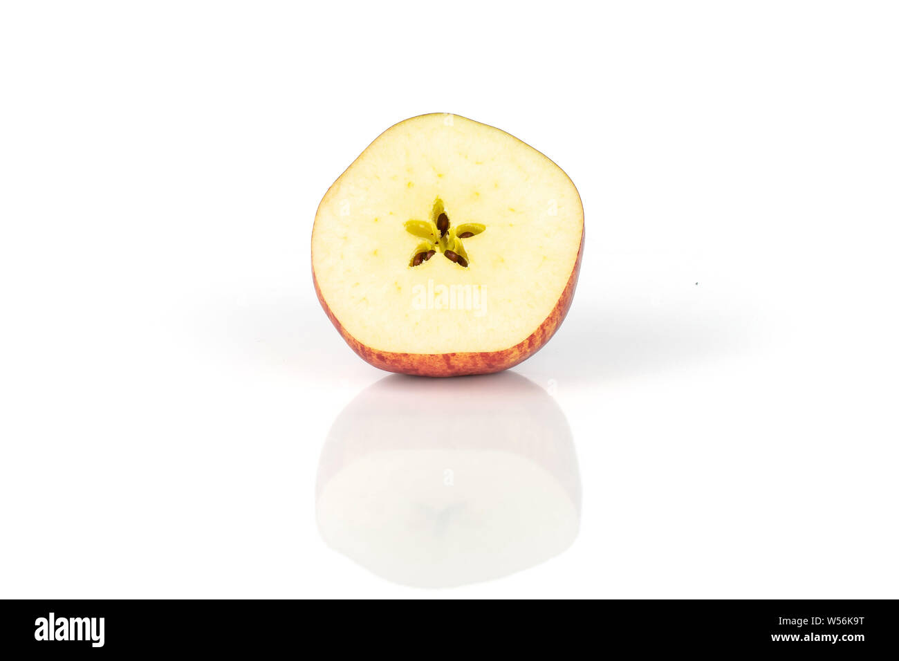 One half of fresh apple red delicious with a star facing front isolated ...