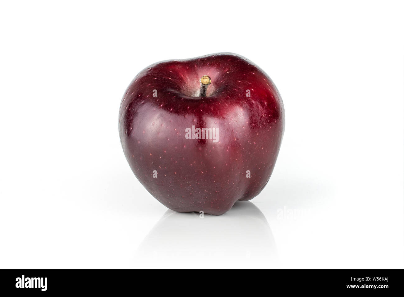 One whole dark fresh apple red delicious isolated on white background ...