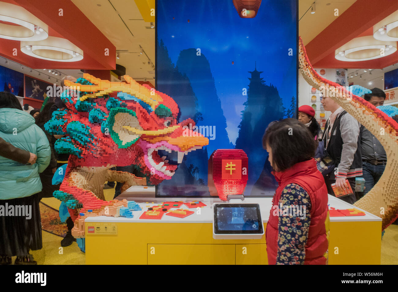 Customers shop in the first Beijing flagship store in the Wangfujing ...