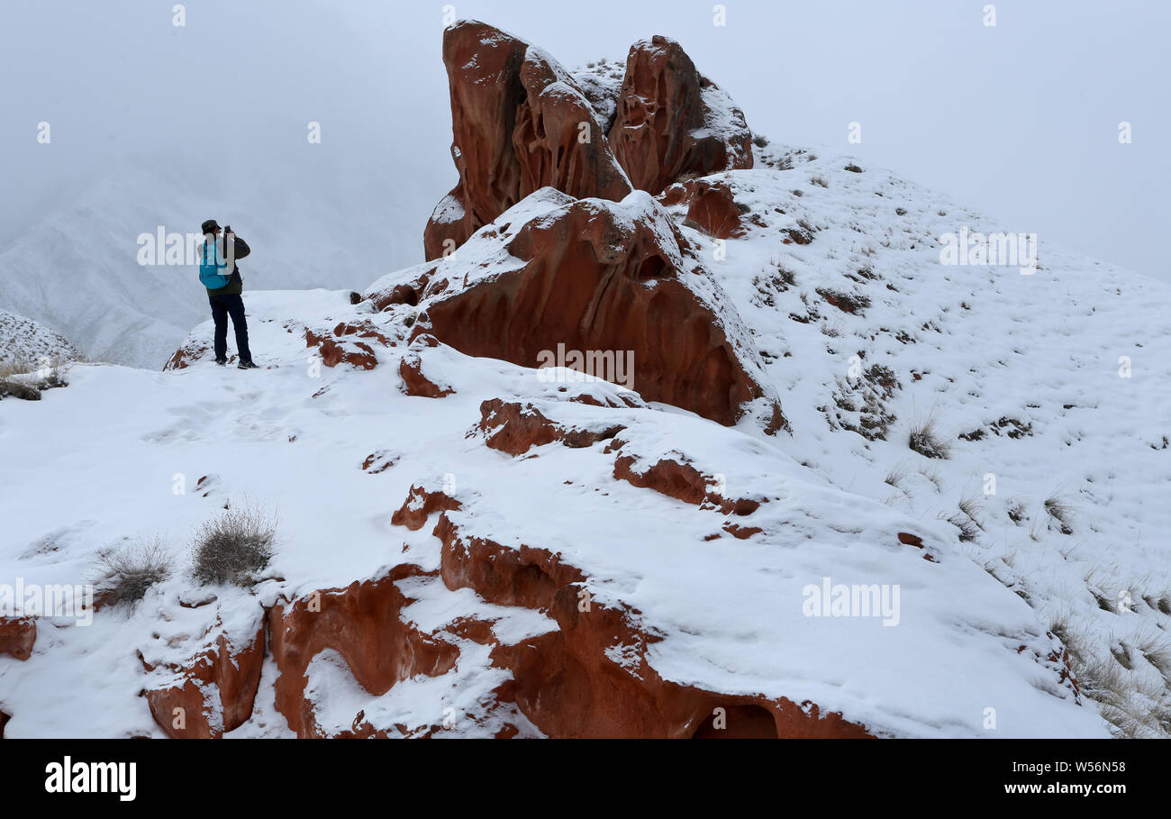 Landscape of the Danxia landform covered with snow during the Spring ...