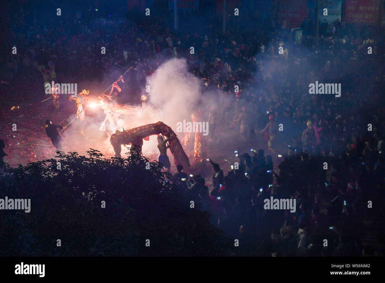 Local Chinese people conduct firecracker dragon performance to ...