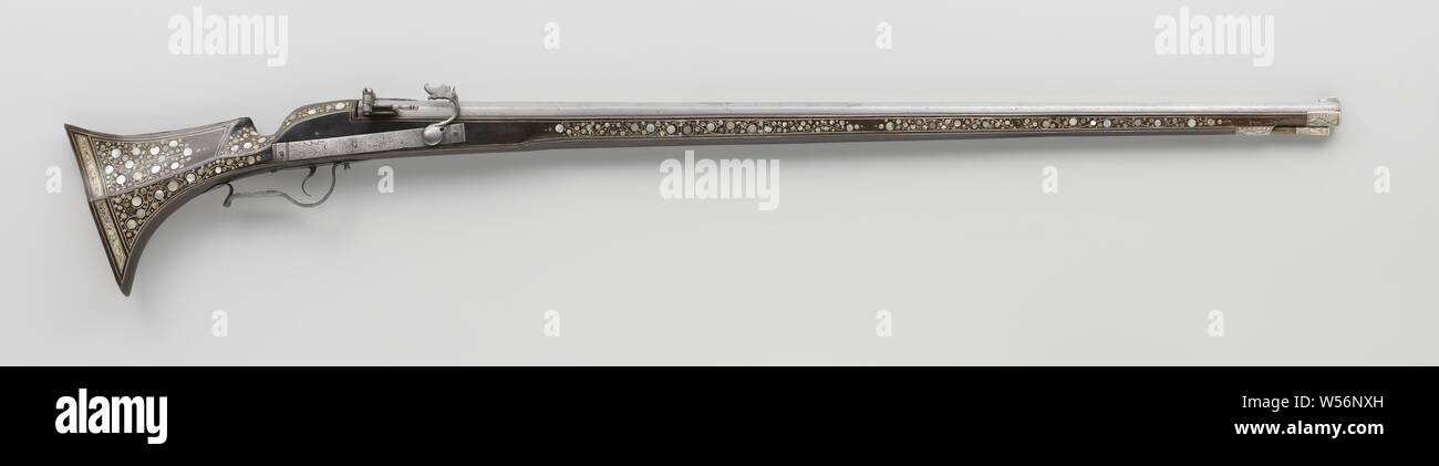 Matchlock caliver, The rectangular lock plate is cut with groups of ...