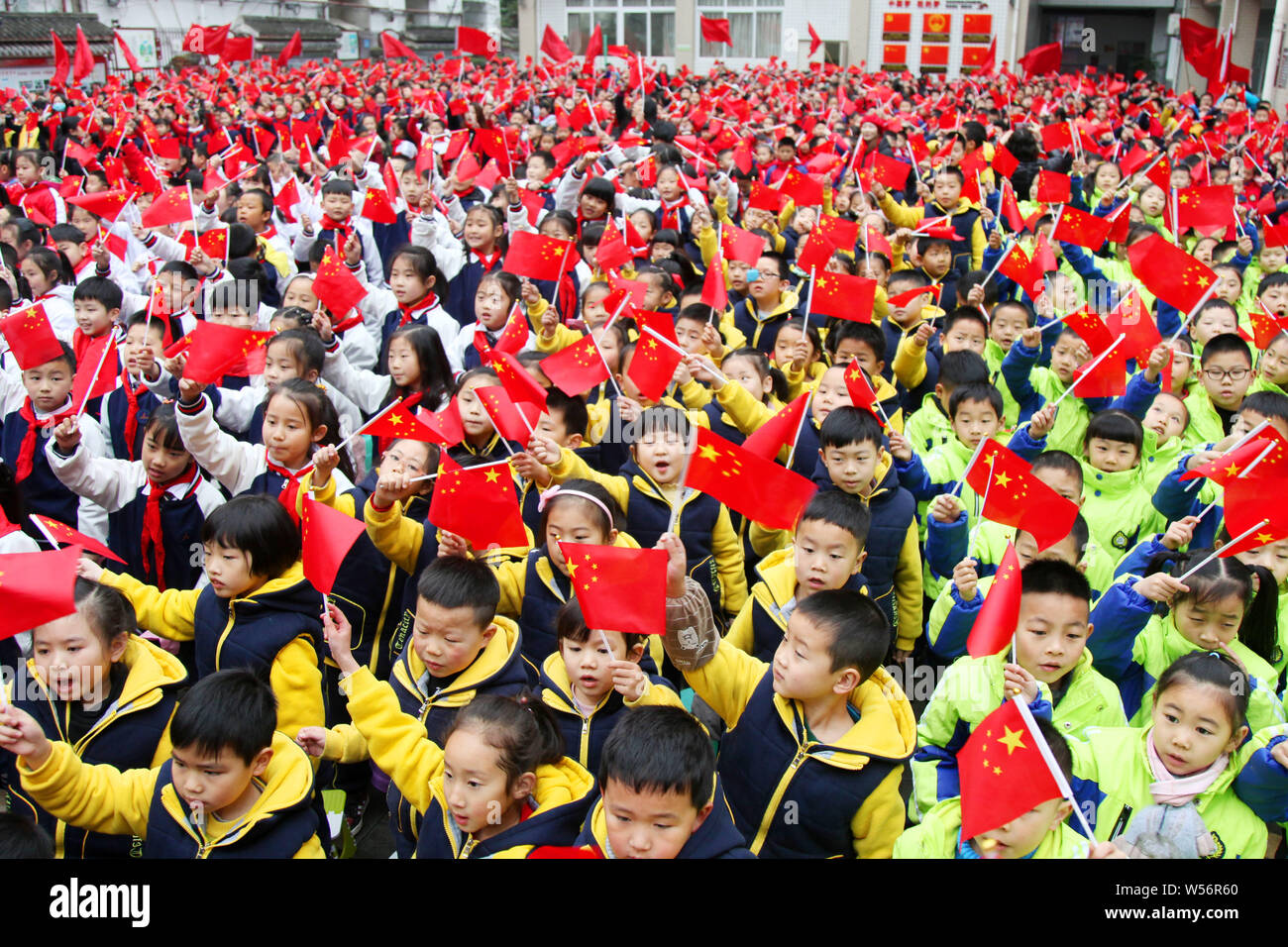 Young Chinese students wave Chinese national flags during the opening ...