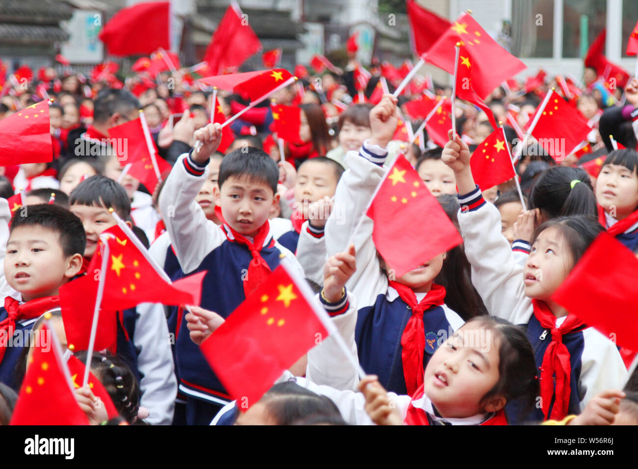 Young Chinese students wave Chinese national flags during the opening ...