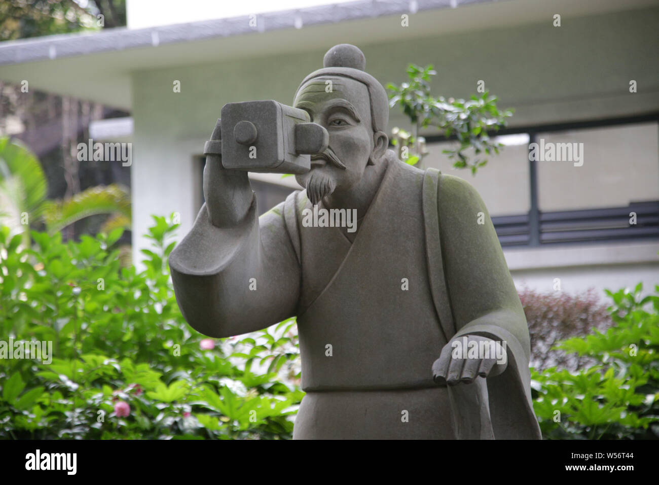 A sculpture of an elderly man dressed in costumes of ancient times ...