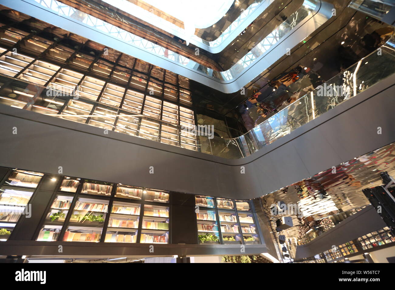 Books are placed on the four-storey-high book wall with a height of 18 ...