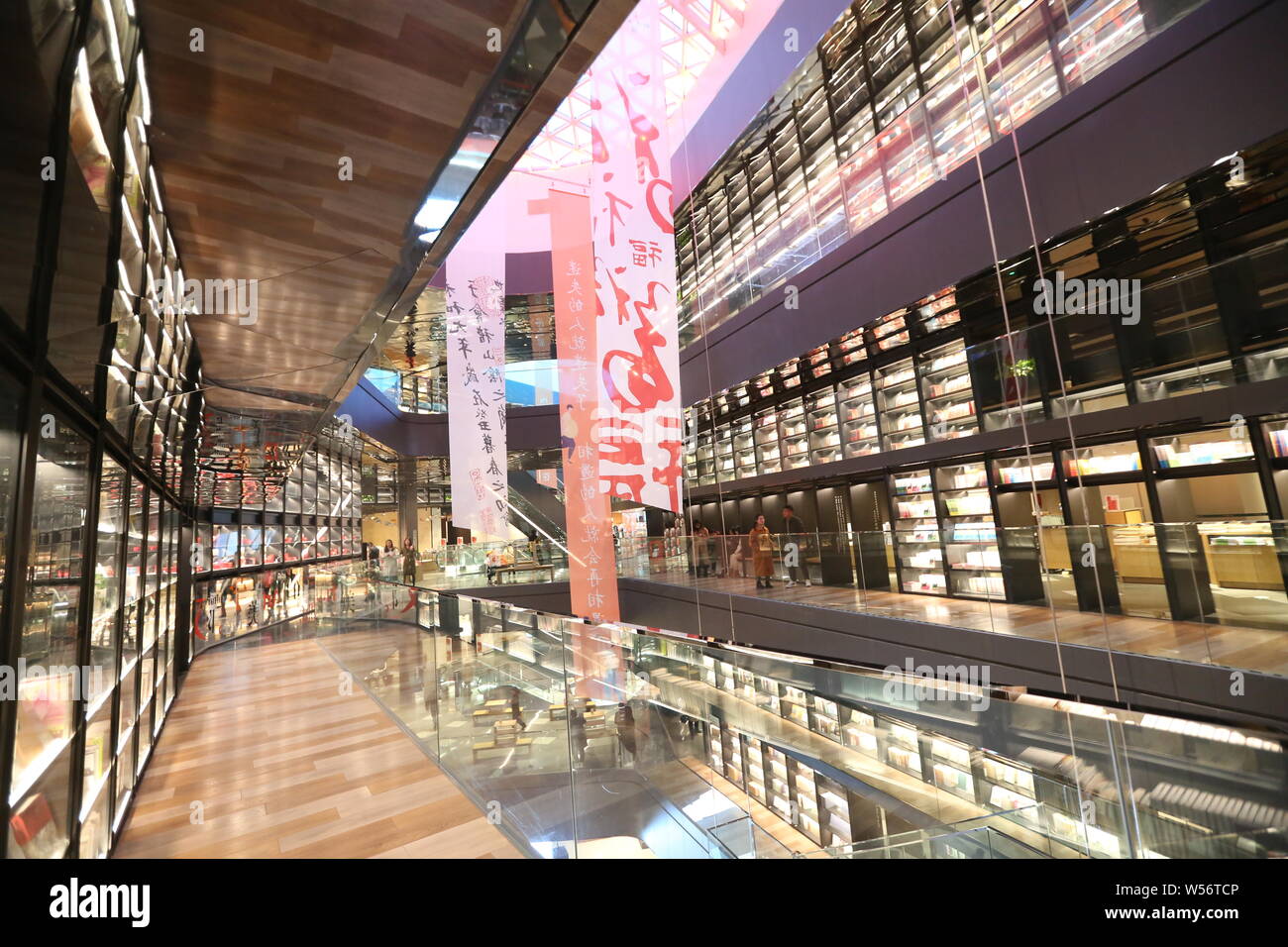 Books are placed on the four-storey-high book wall with a height of 18 ...