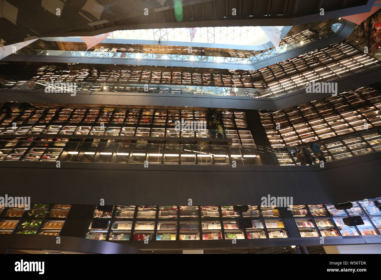 Books are placed on the four-storey-high book wall with a height of 18 ...