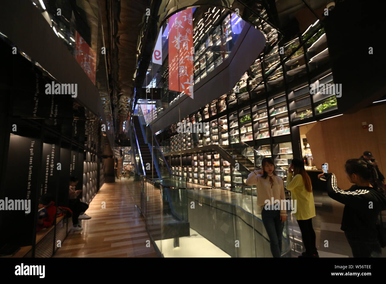Books are placed on the four-storey-high book wall with a height of 18 ...