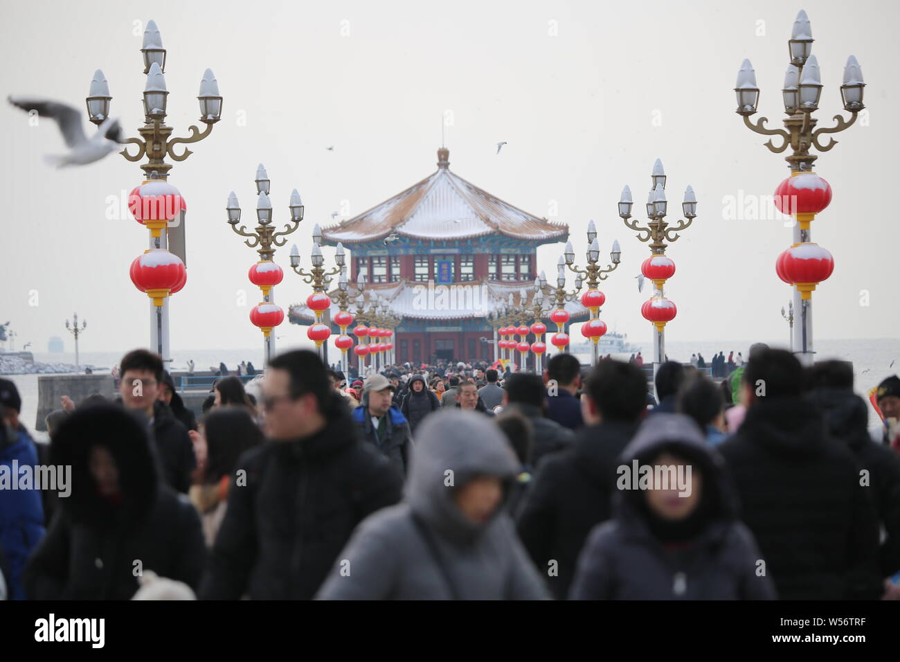 Tourists visit the Zhanqiao Pier in the snow in Qingdao city, east ...