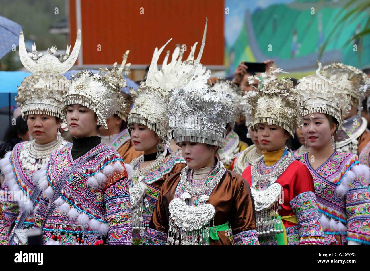 A Chinese girl of Miao ethnic group dressed in the traditional silver ...