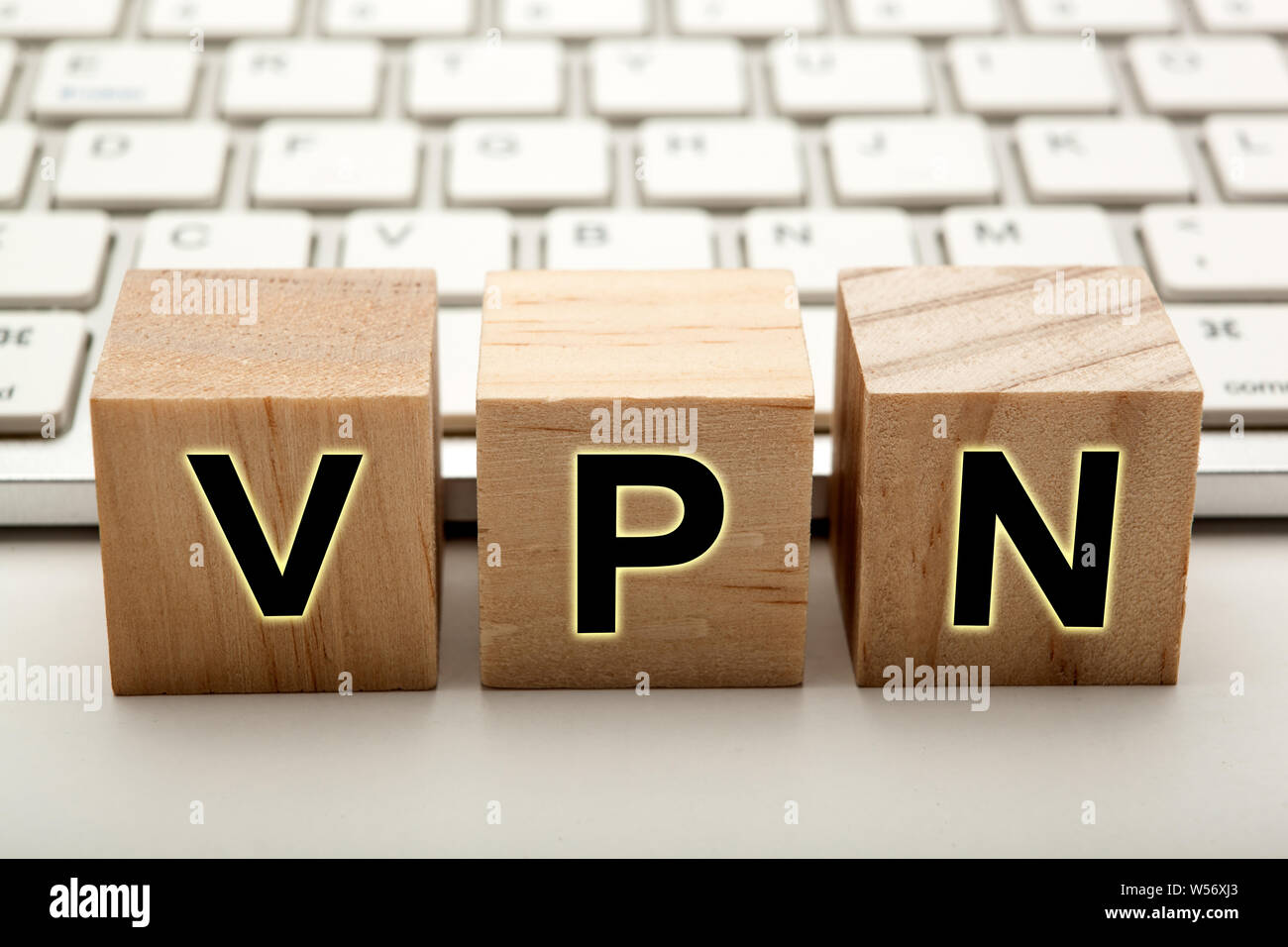 three wooden cubes with inscription VPN with the computer keyboard ...