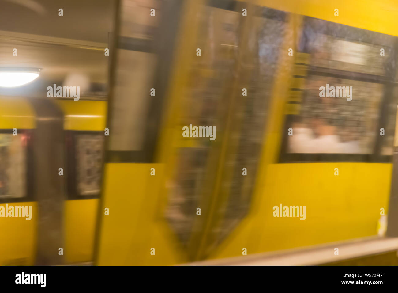Two yellow subways pass the subway station Stock Photo - Alamy