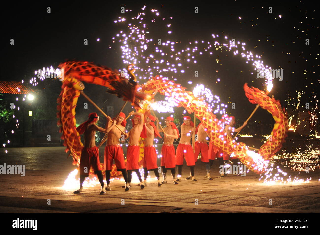 Chinese artists perform dragon dance as sparks created by molten iron ...