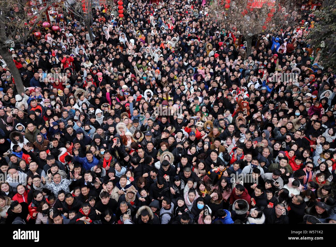 Tourists crowd the Millennium City Park to get red pocket money from ...
