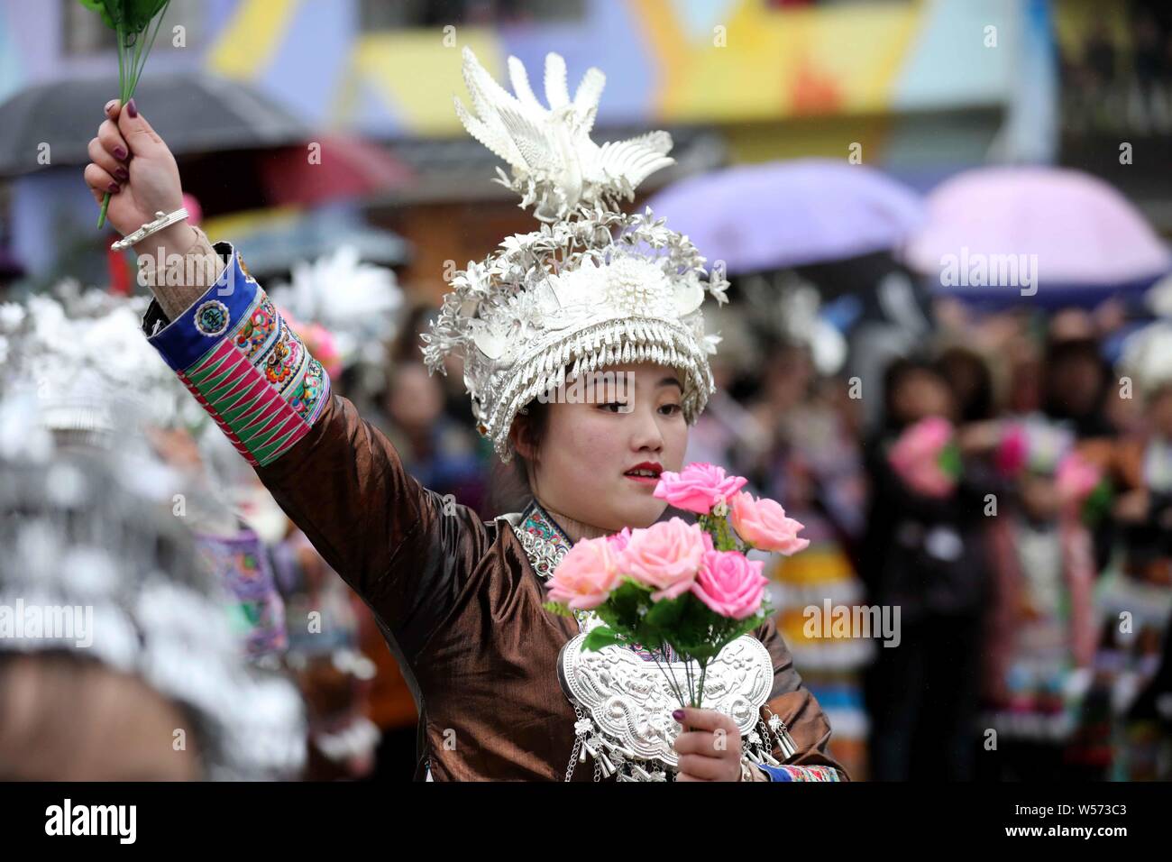 A Chinese girl of Miao ethnic group dressed in the traditional silver ...