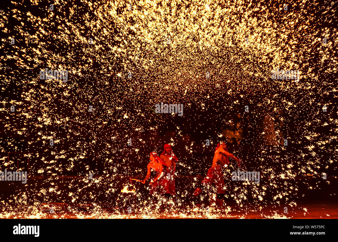Chinese entertainers perform a fire dragon dance in a shower of molten ...