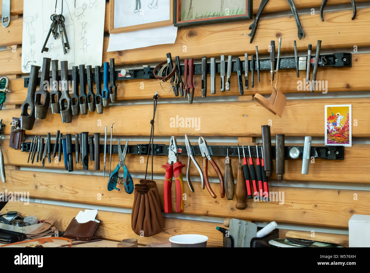 Hammer on shelf and leather in workshop Stock Photo - Alamy