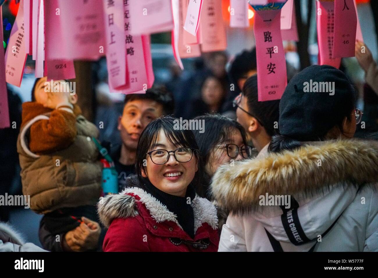 Citizens and tourists try to solve the lantern riddles to celebrate the ...