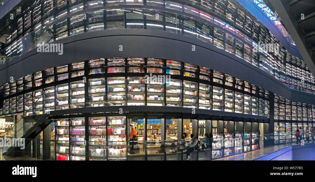 Books are placed on the four-storey-high book wall with a height of 18 ...