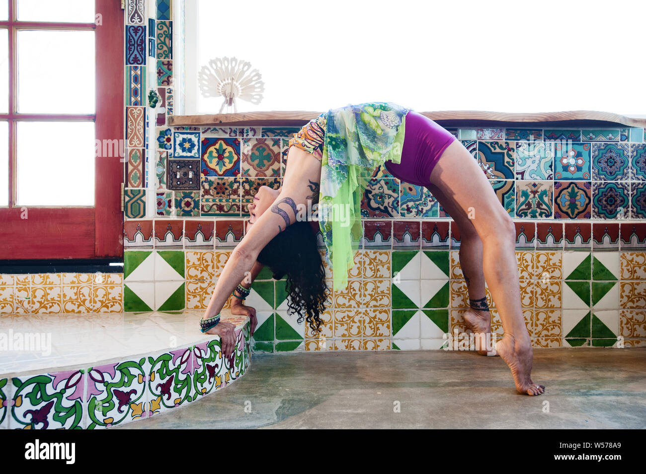 Colorfully dressed yogini in a mosaic house Stock Photo - Alamy