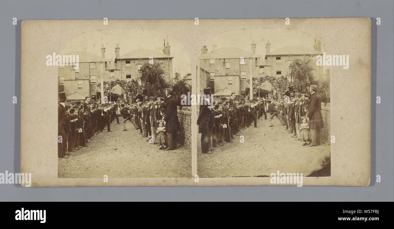 Wedding couple under an arch of honor among a hedge of people, bride ...