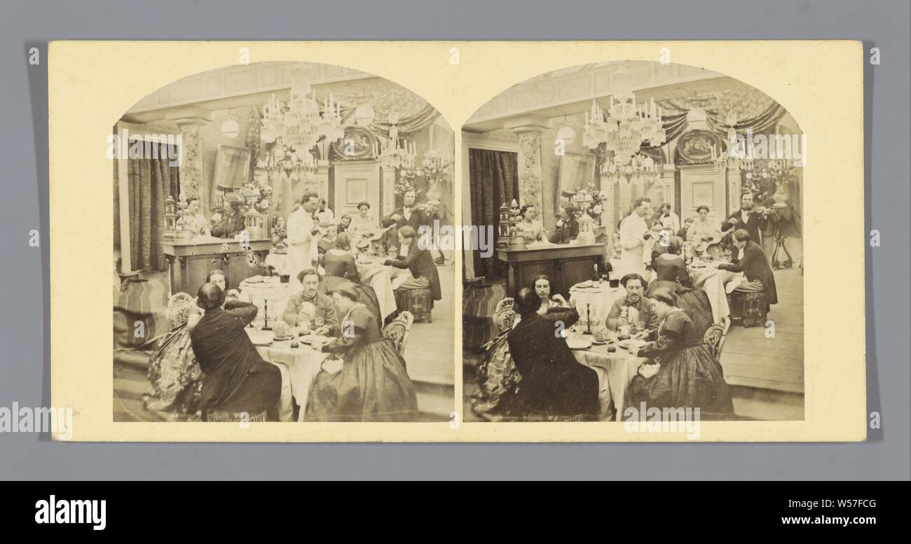 Interior of a restaurant with tables with people, a waiter and a ...