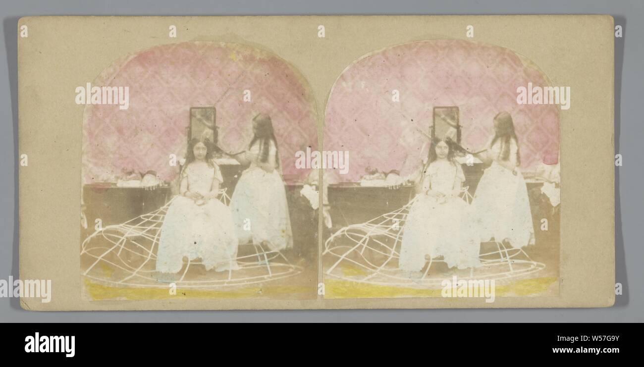 Scene in boudoir: girl combs hair from other girl in crinoline ...