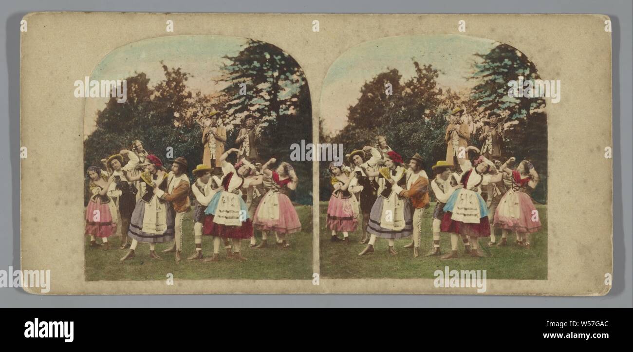 Scenery in the garden: dancing couples in traditional costumes ...