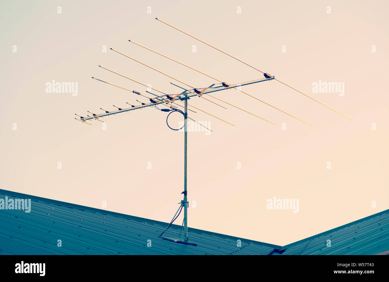 Digital TV aerial or antenna on top of a house with retro Instagram ...