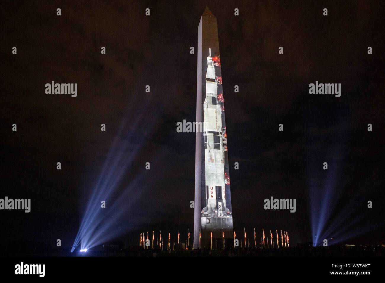 A scale image of Apollo 11 is projected onto the Washington Monument in ...