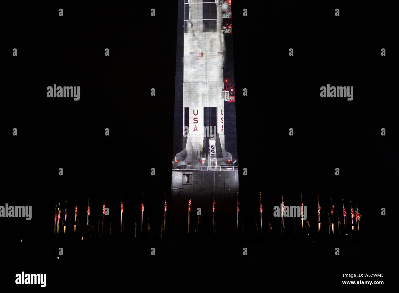 A scale image of Apollo 11 is projected onto the Washington Monument in ...