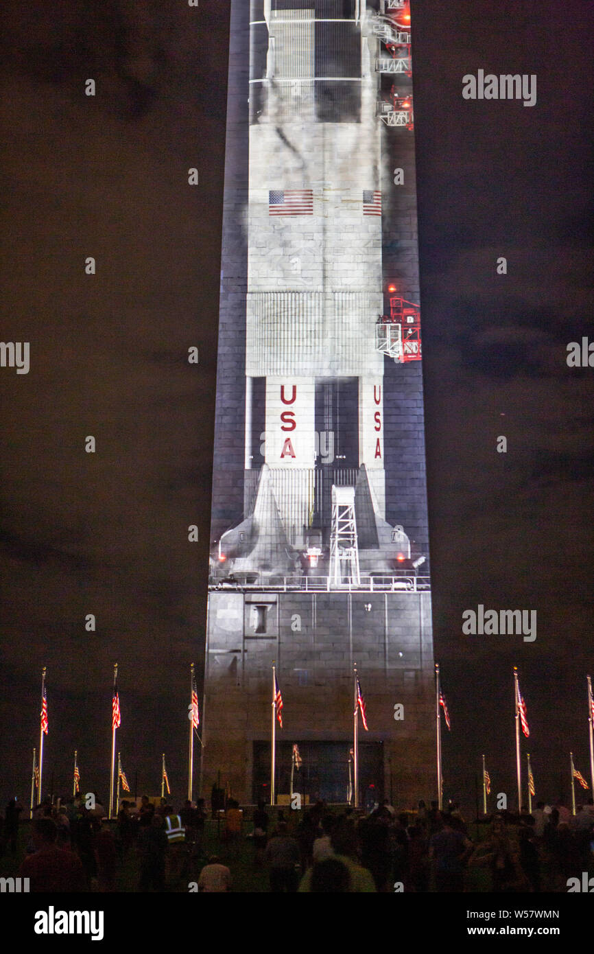 A scale image of Apollo 11 is projected onto the Washington Monument in ...