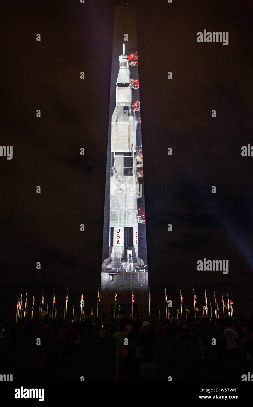 A scale image of Apollo 11 is projected onto the Washington Monument in ...