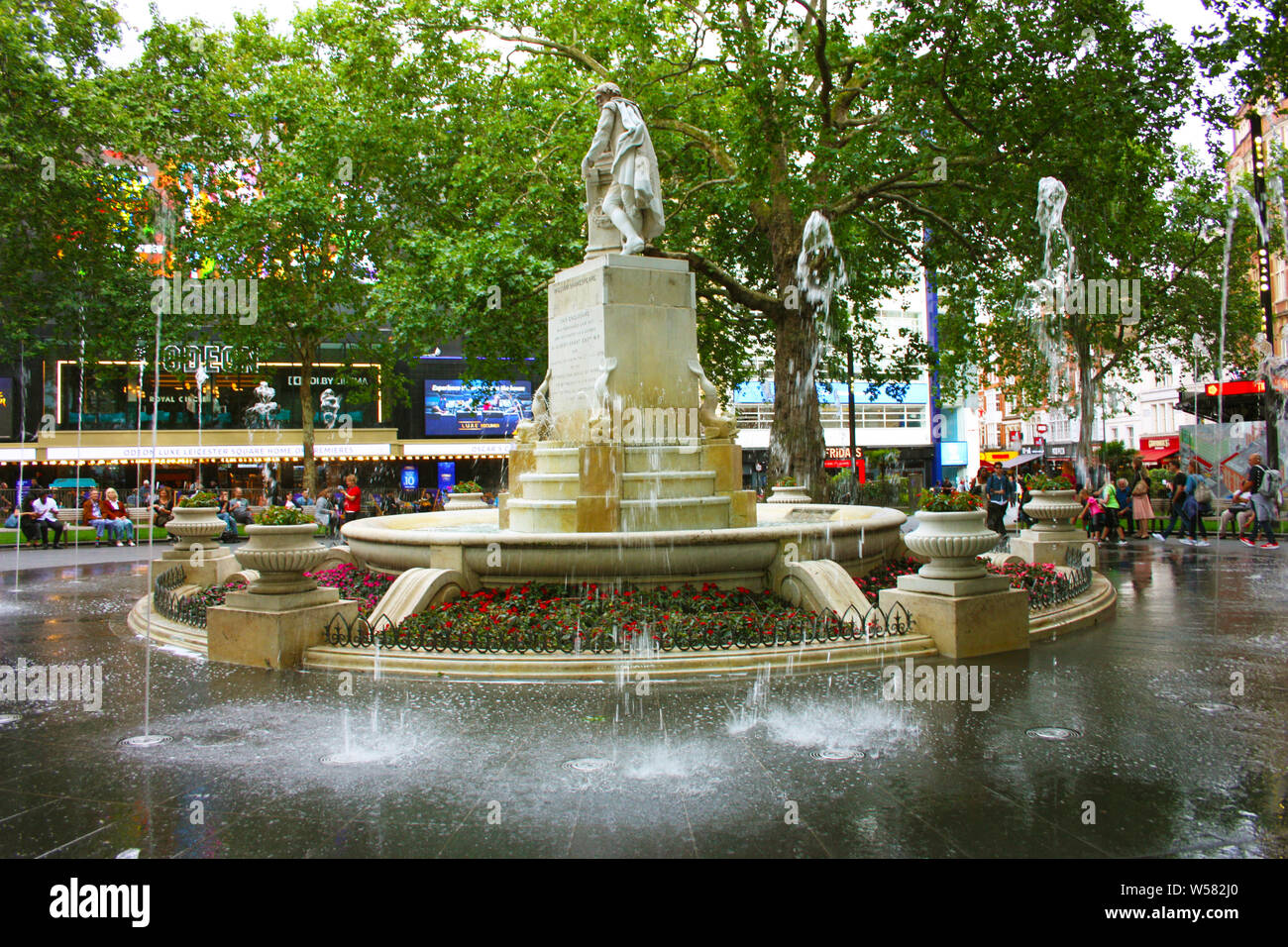 fountain with a statue in one of the largest squares with a garden in ...