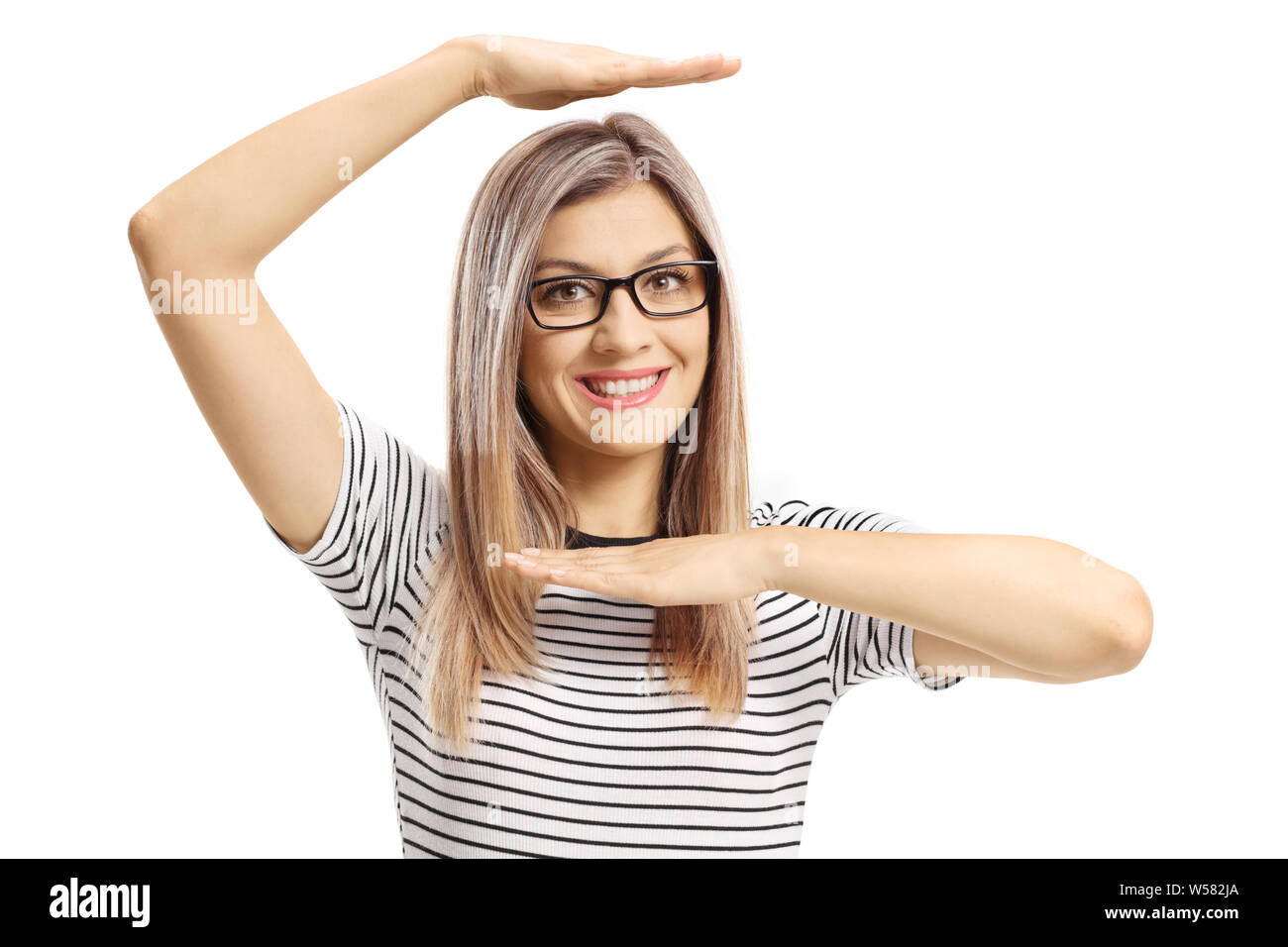Beautiful young woman gesturing a frame with hands above and under her ...