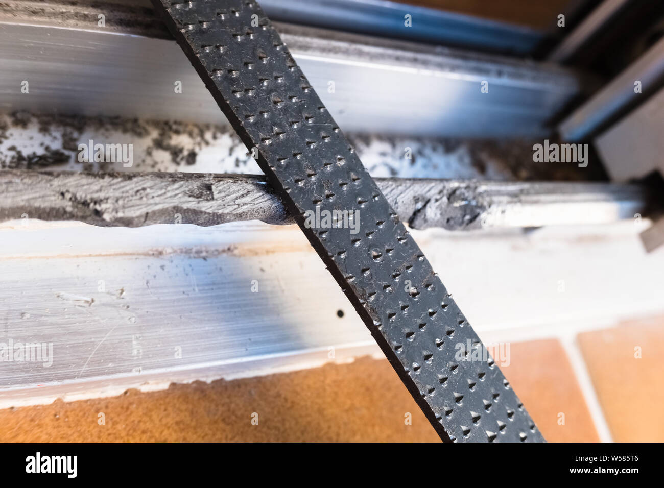 Close-up of a metal file, used to repair the aluminum frame of a window ...